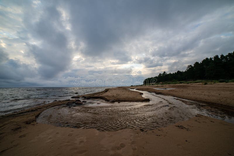 Storm Clouds Forming Over Clear Sea Beach with Rocks and Clear S Stock ...