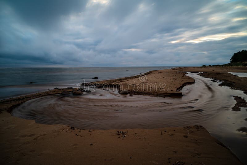 Storm Clouds Forming Over Clear Sea Beach with Rocks and Clear S Stock ...