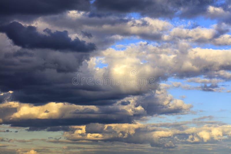 Storm Clouds Gather in the Sky in the Rays of the Setting Sun Stock ...
