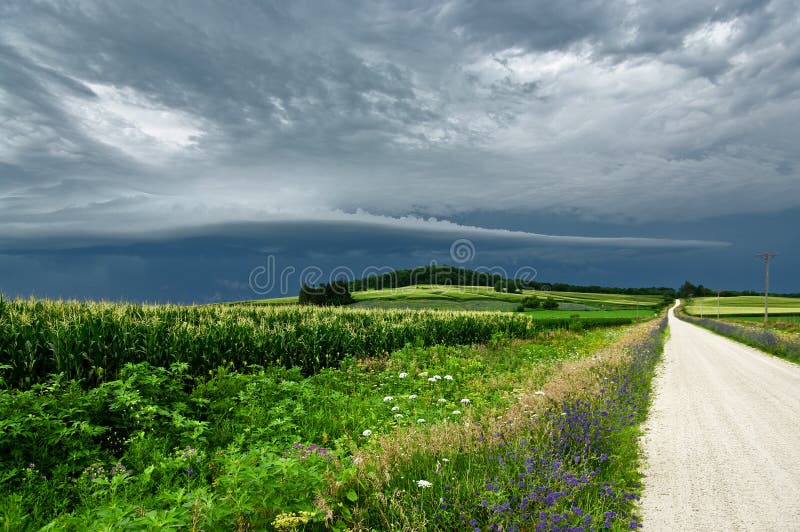 Storm Clouds Over a Country Road Stock Photo - Image of horizon, clouds ...