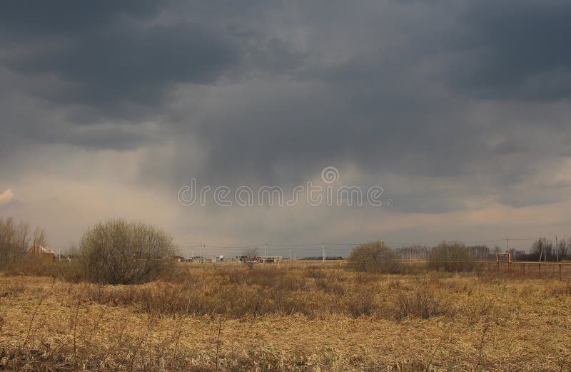 Storm Clouds Over a Field in Nature with a Forest Landscape Stock Image ...