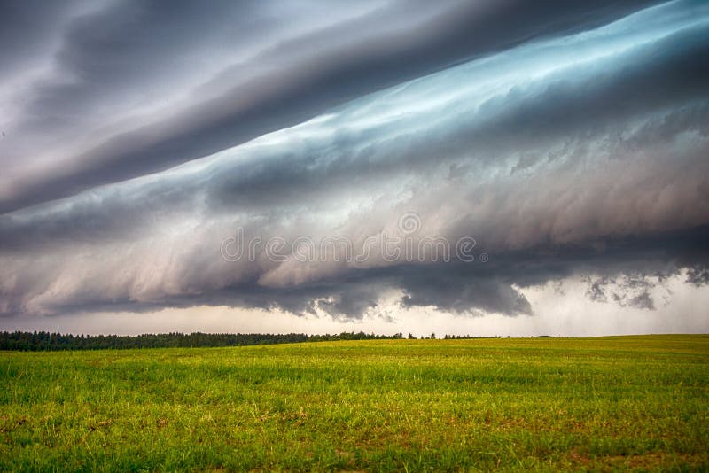 Storm Clouds Over the Sloping Field Stock Image - Image of cloud, grass ...