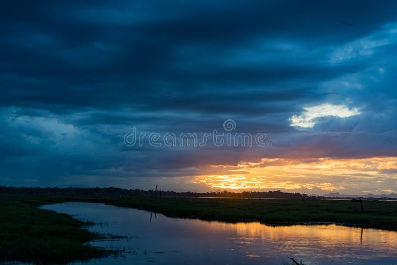 Storm Clouds Over the Water and Sunset Over the Lake Stock Photo ...