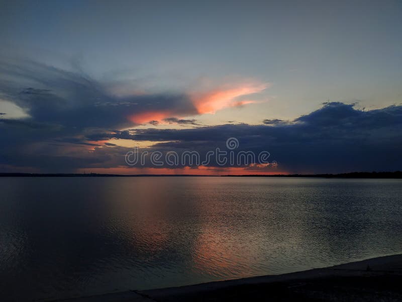 Storm Clouds with Rain Over the Lake at Sunset Stock Photo - Image of ...