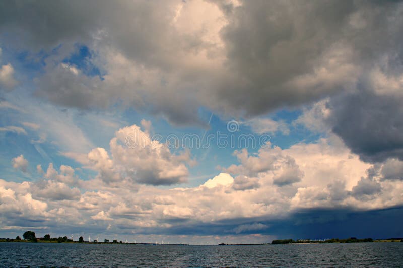 Storm Clouds with Rain Over the River Haringvliet Stock Image - Image ...
