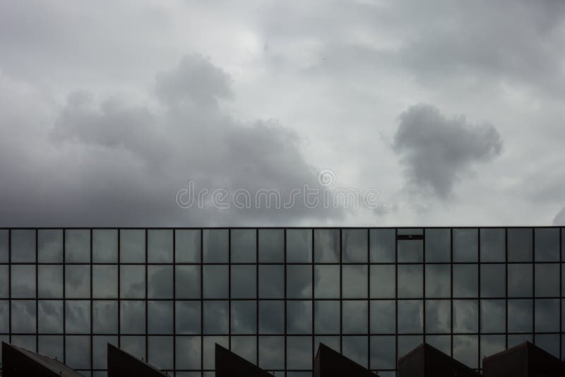 Storm Clouds Reflect in Windows of Office Building/ Mirror Windows with ...