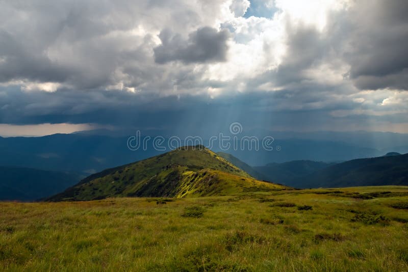 Storm Clouds and Sun Rays Over the Mountains Stock Photo - Image of ...