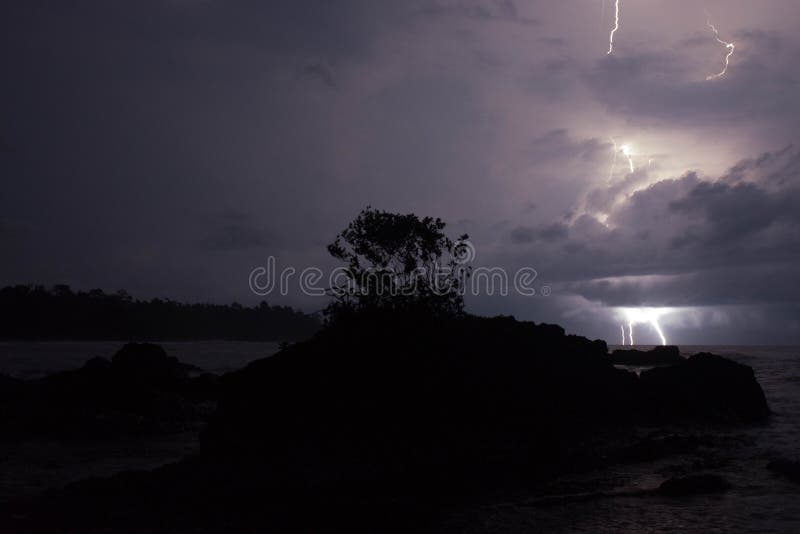 Multiple Lightning Strikes Over Ocean with Island Stock Image - Image ...