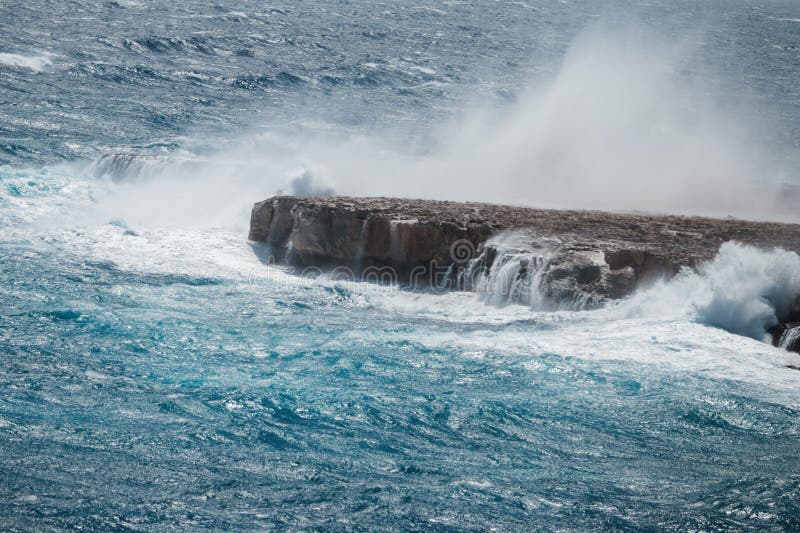 Waves Crash Against the Rocks on the Ocean Shore. Blue Sea Water with ...