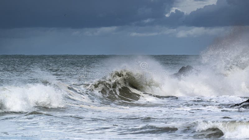 Storm Waves Breaking Over Rocks Stock Photo - Image of rolling, spray ...