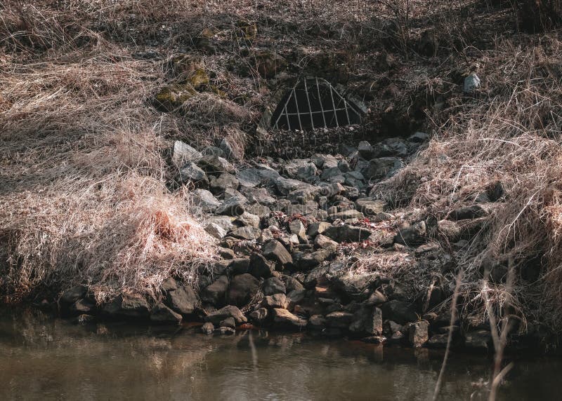 Stormwater Drain and Rocks on a Riverbed for Erosion Control. Watershed ...