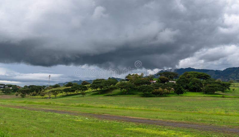 Stormy Afternoon with Many Clouds Over the Country House. Stock Image ...