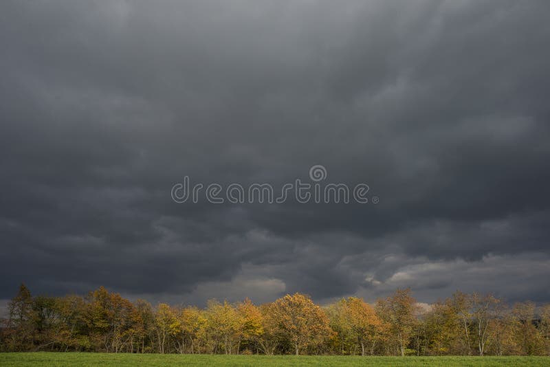 Stormy Dark Clouds Over the Trees and Field. the Fall Scene. Stock ...