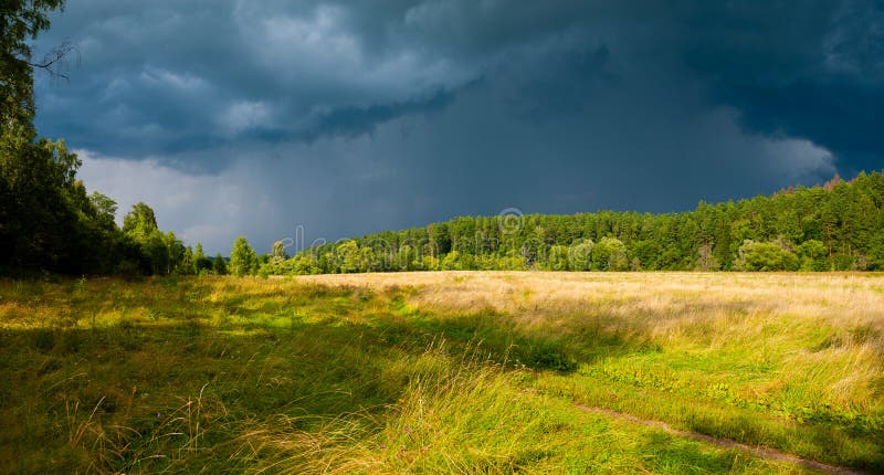 Field and stormy skies stock image. Image of light, landscape - 18028339
