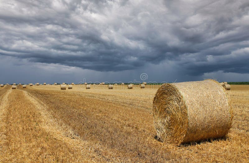 Stormy Sky Over Field with Straw Bale Stock Photo - Image of bale ...