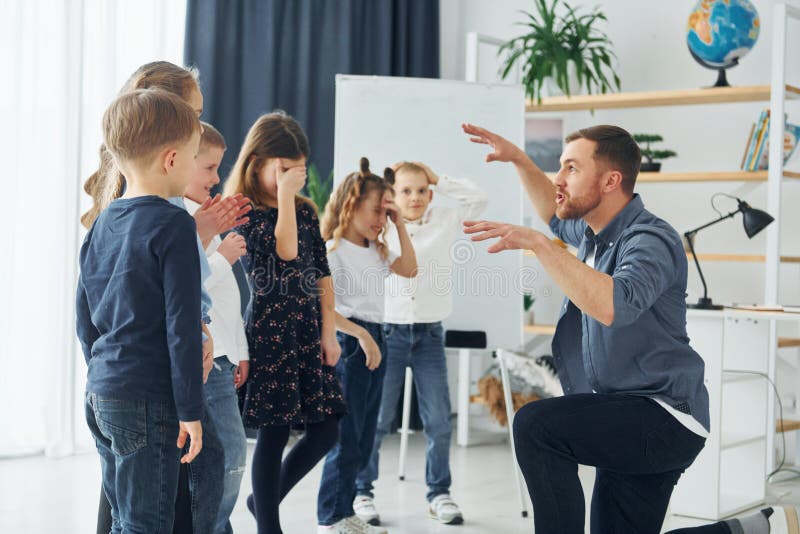 Storyteller with Interesting Information. Group of Children Students in ...