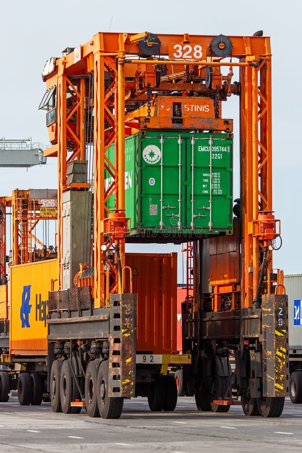 Straddle Carrier Moving Containers in a Container Terminal. Editorial ...