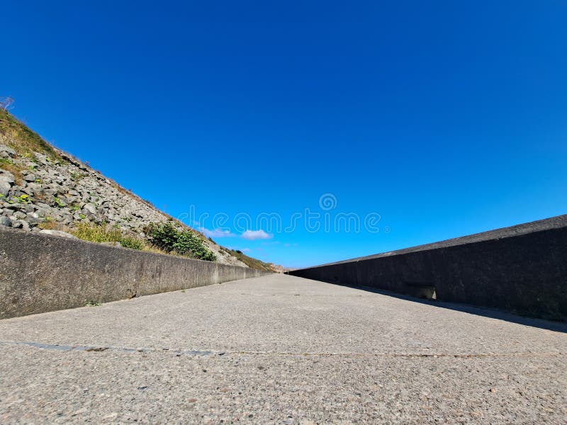 Straight Pavement Under a Clear Blue Sky Stock Photo - Image of mount ...