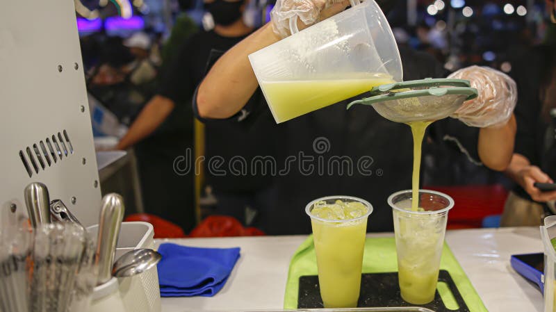 Straining Sugar Cane into a Clear Plastic Glass Stock Image - Image of ...