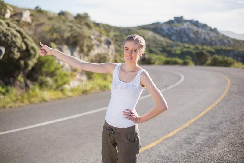 Stranded Woman Hitching a Lift and Smiling at Camera Stock Photo ...