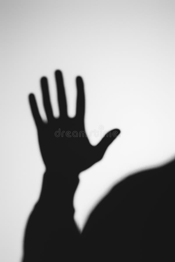 Mysterious Blurry Shadow Of Person Raising Hands On Grey Stock Image ...