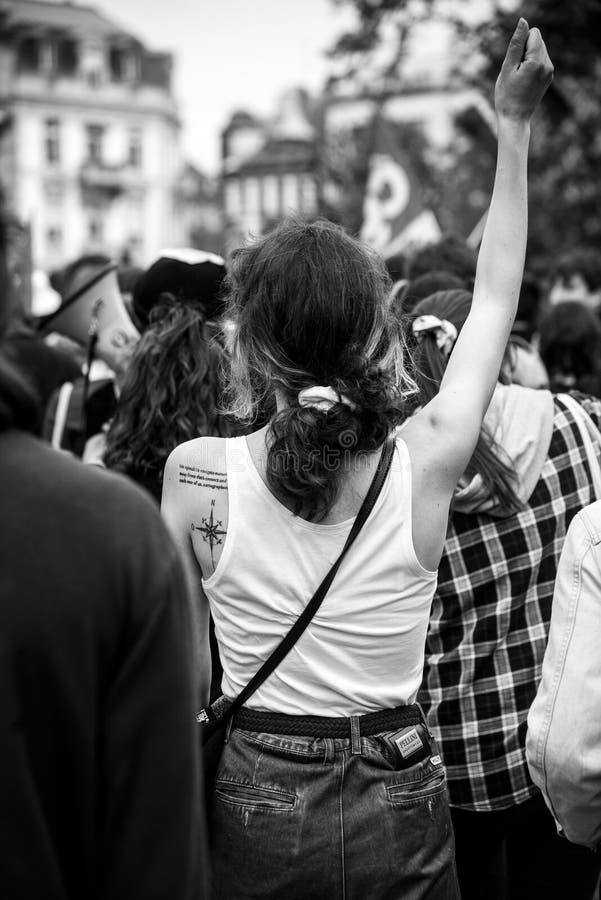 Portrait On Back View Of Antifascist Girl Protesting In The Street