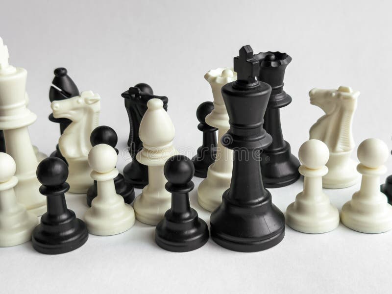 Strategic Chess Game Setup Featuring Black and White Pieces on Gray ...