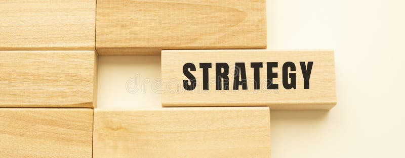 STRATEGY Text on a Strip of Wood Lying on a White Table. Stock Image ...