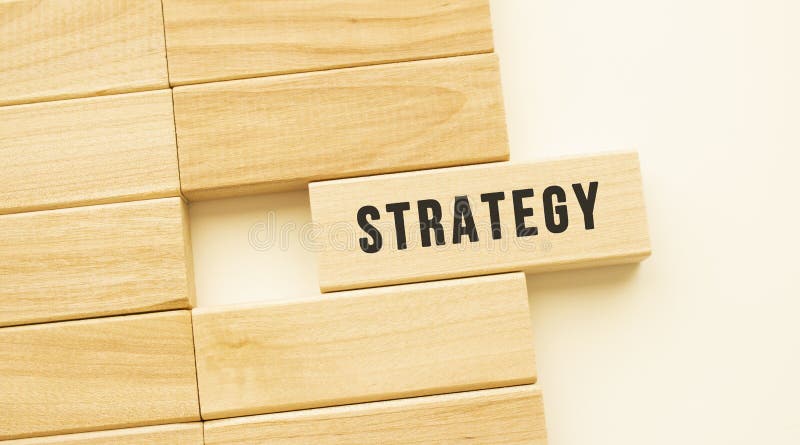 STRATEGY Text on a Strip of Wood Lying on a White Table Stock Image ...