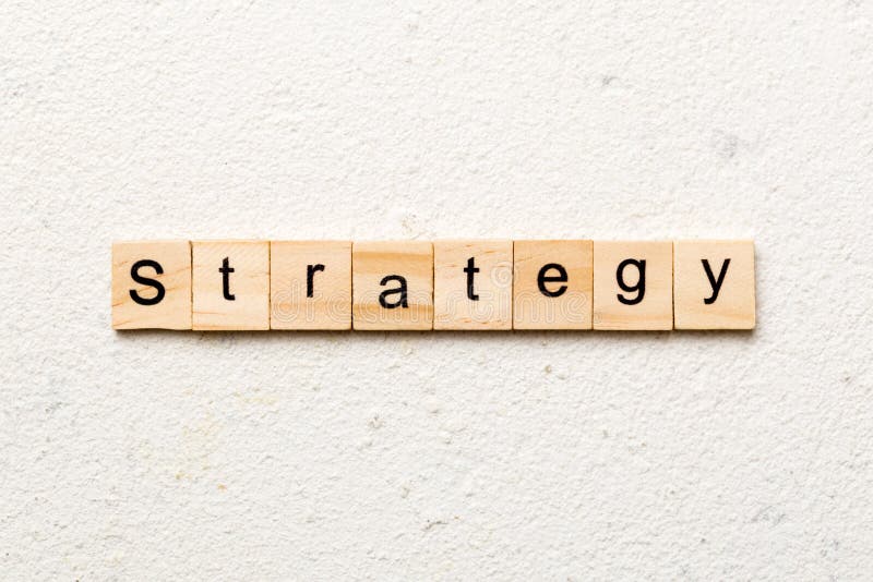 STRATEGY Word Written on Wood Block. STRATEGY Text on Cement Table for ...