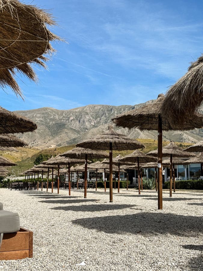 Straw Beach Umbrellas in Rows on the Beach Stock Photo - Image of ...