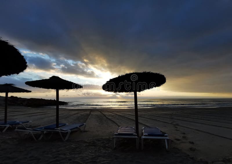 Straw Beach Umbrellas, Sunset Stock Image - Image of blue, straw: 235369879