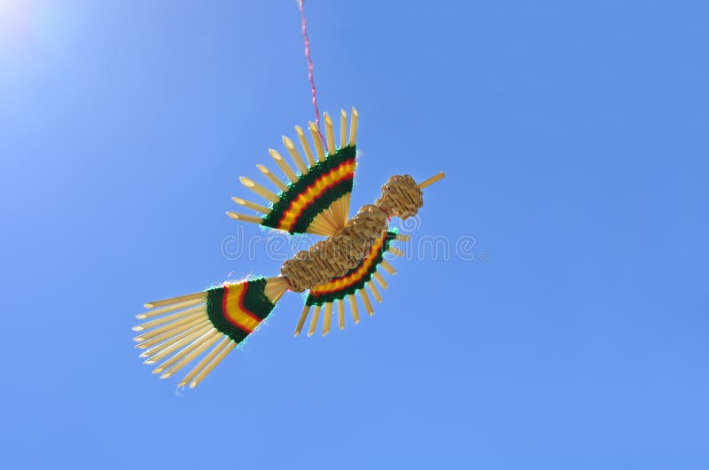 Straw Bird Flying on a Thread Against Bright Blue Sky Stock Image ...