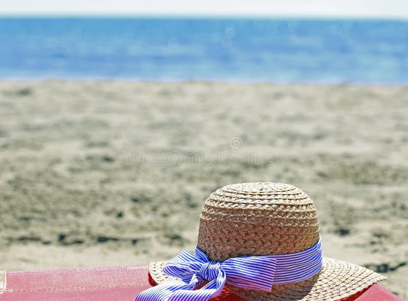 Straw Hat Above the Beach Bed by the Sea in Summer Stock Photo - Image ...
