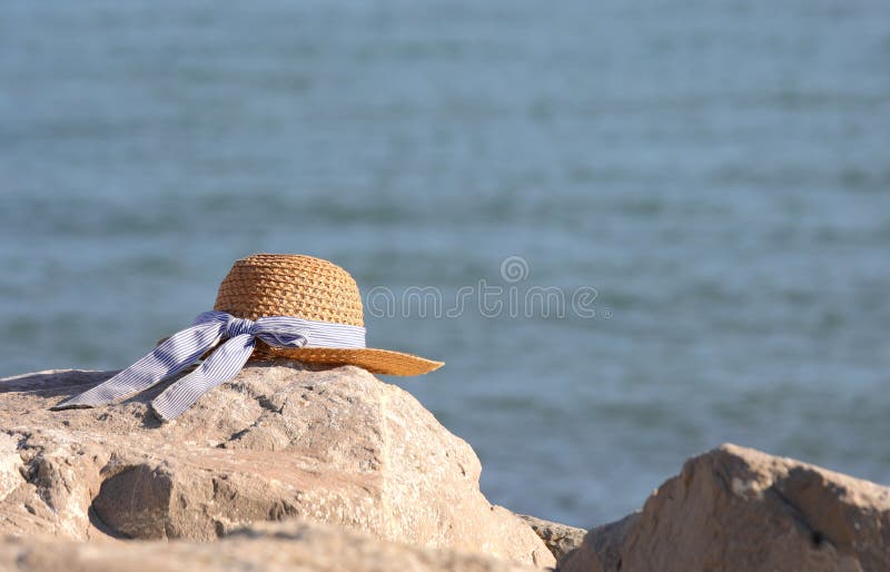 Straw Hat on the Rocks by the Sea in Summer and Space for a Cust Stock ...