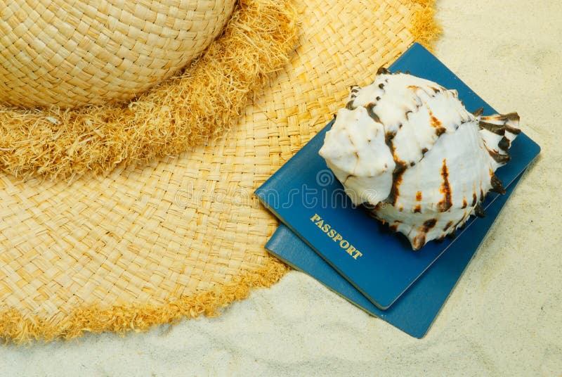 Straw Hat, Seashell And Passports On The Sand Picture. Image: 5088274