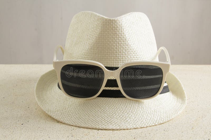 Straw Hat with White Rimmed Sunglasses Combination on Table, Front View ...