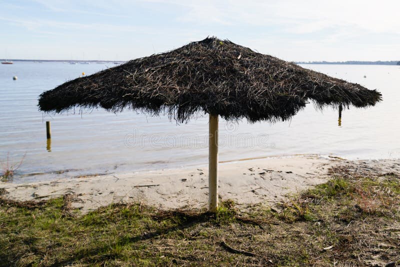 Straw Parasol in Sand Lake Beach Stock Image - Image of france, spring ...