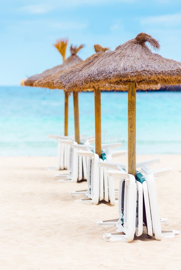Straw Parasols and Beds on the Sandy Beach Stock Photo - Image of ...