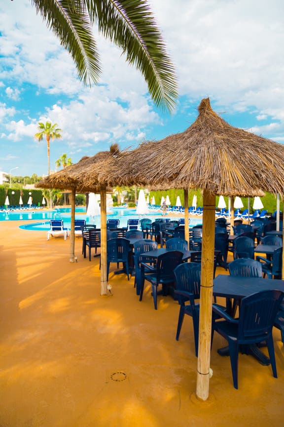 Straw Parasols and Beds on the Sandy Beach. Stock Photo - Image of ...