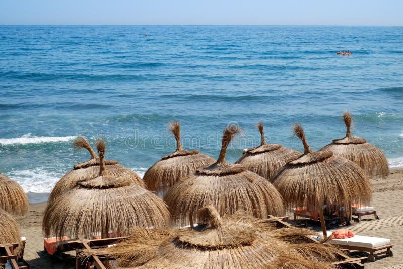 Straw Umbrellas and Sunbeds on the Beach Stock Photo - Image of ...