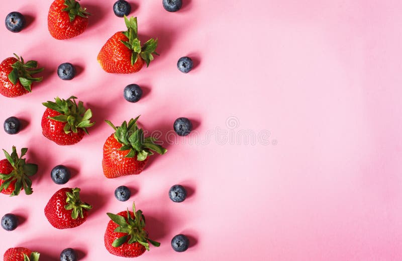 Strawberries and Blueberries on Pink Background. Strawberry and ...
