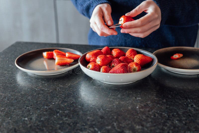 Strawberries Cutting. Hands Cut Strawberries and Put in a Plate. Preparing Strawberries for ...