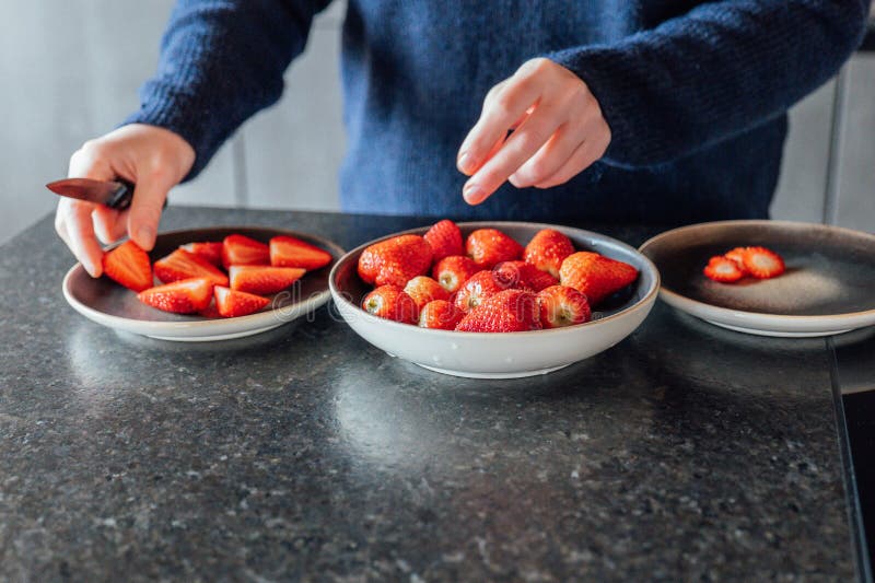Strawberries Cutting.Hands Cut Strawberries and Put in a Plate Stock ...