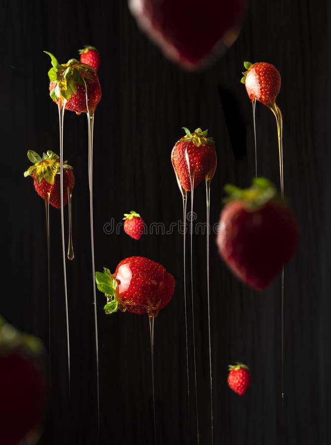 Strawberries Falling Down and Dripping with Honey Stock Photo - Image ...