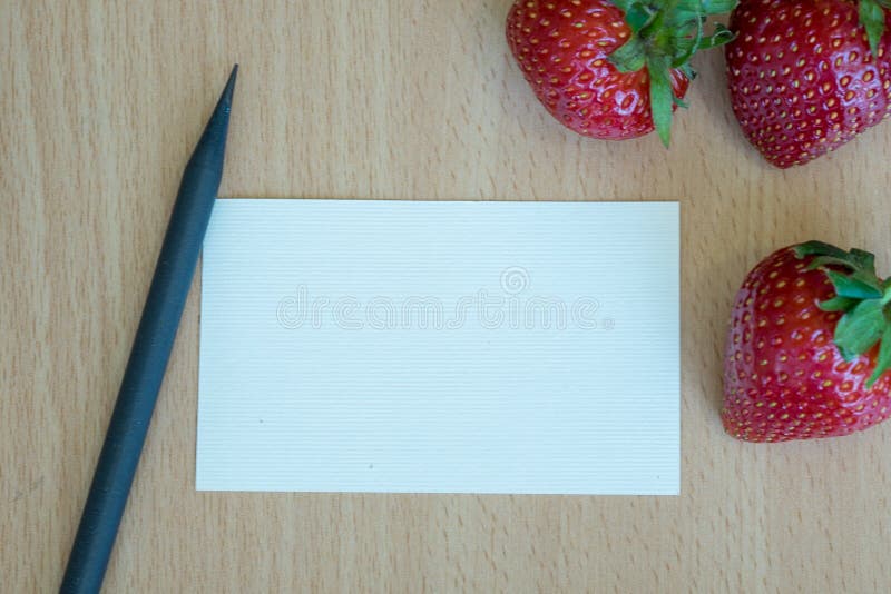 Strawberries and Note Paper on Wooden Table Background Stock Image ...