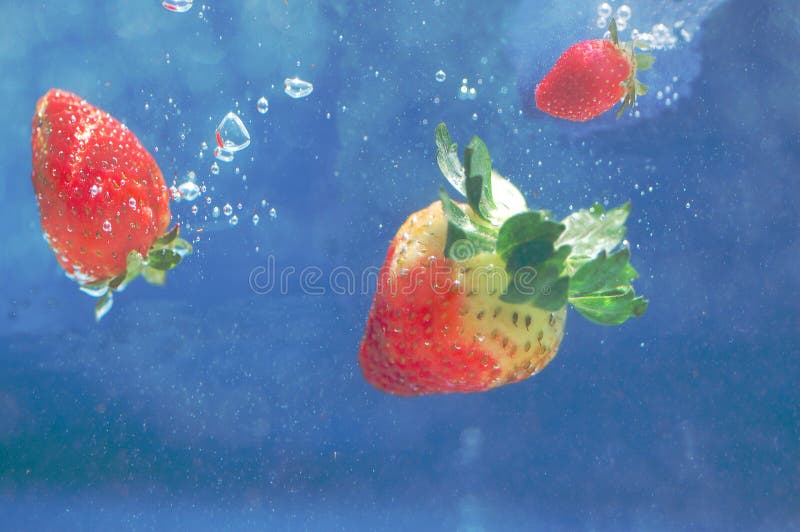 Strawberries into water stock image. Image of fruit, drops - 5861137