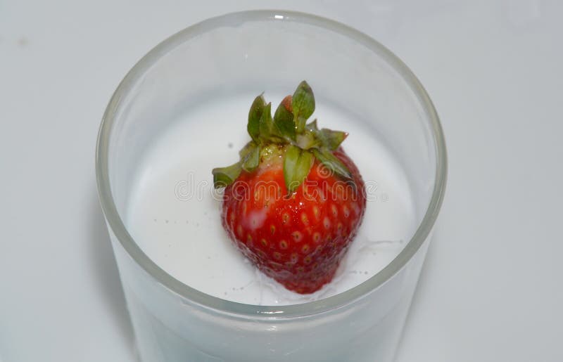 Strawberry Drop on Milk Glass Stock Image - Image of digest, glass ...