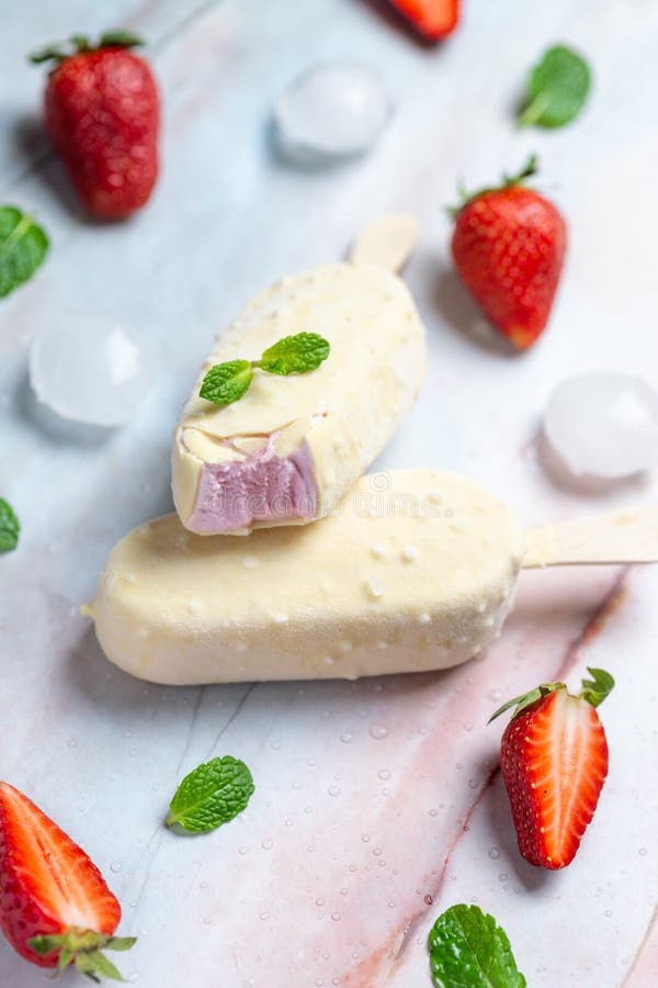 Strawberry Ice Creams on Sticks Covered with White Chocolate on White ...