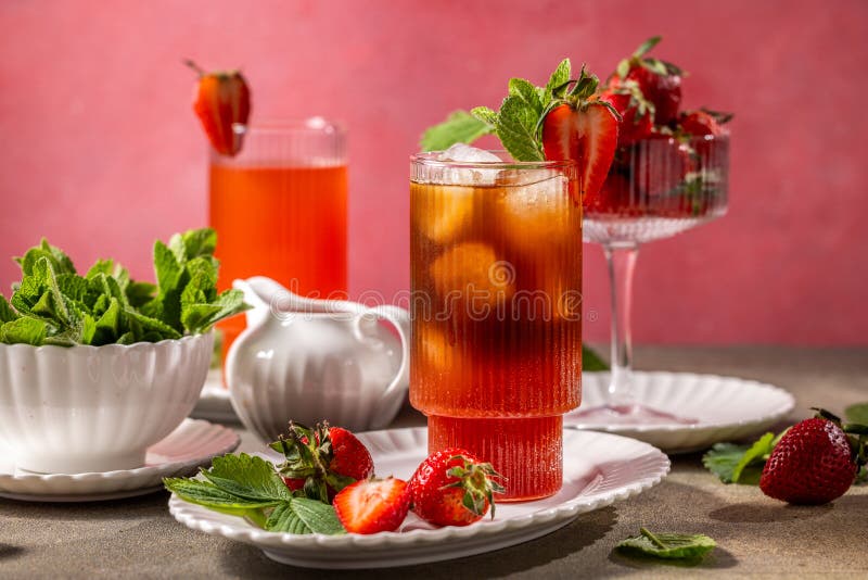 Strawberry Iced Tea with Fresh Mint and Ice Cubes on Pink Background ...